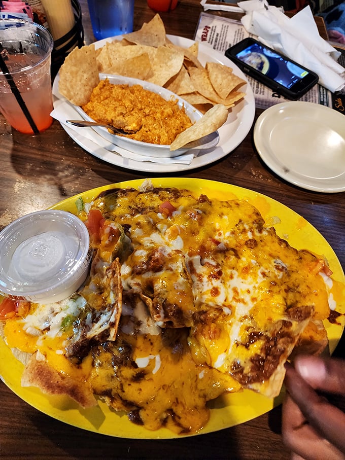Nachos that require a topographical map to navigate—valleys of cheese, mountains of toppings, and not a dry chip in sight.