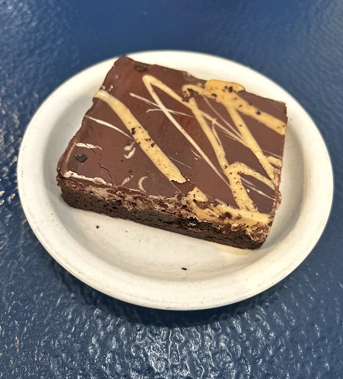 Chocolate brownie artistry that makes you wonder if Willy Wonka retired to Roanoke. Those peanut butter drizzles aren't decoration &ndash; they're an exclamation point.