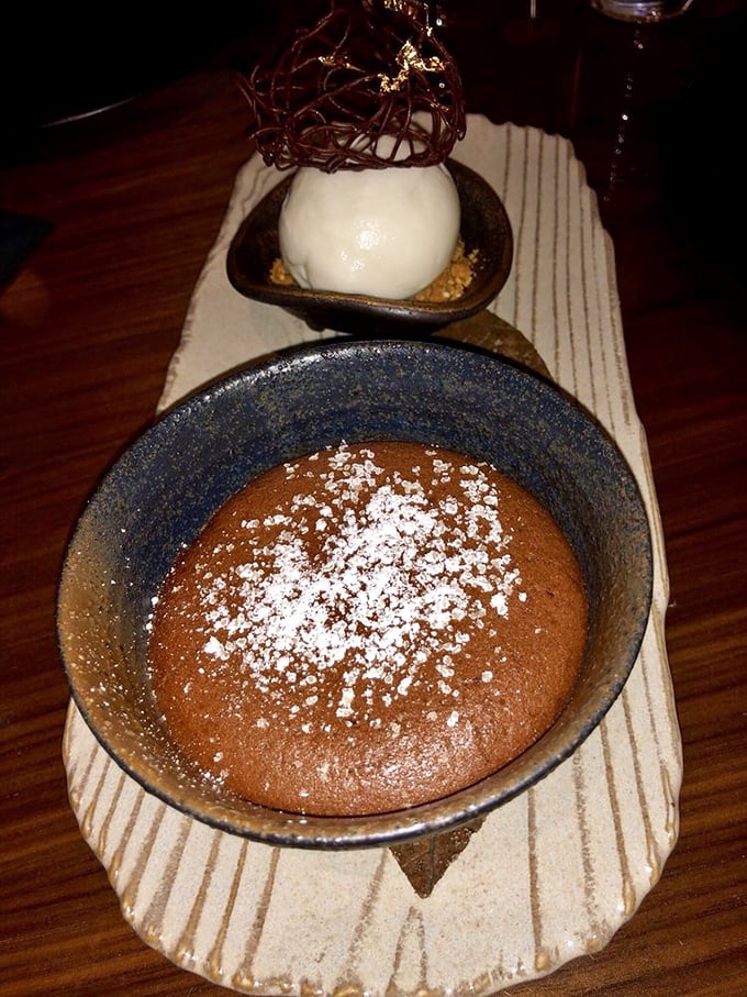 This isn't just chocolate cake&mdash;it's a warm chocolate revelation with a dusting of powdered sugar and what appears to be ice cream standing by for backup.