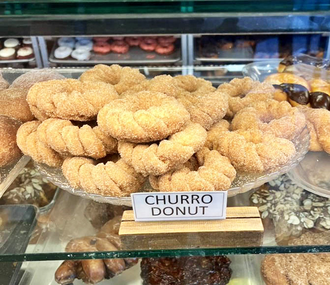 Churro donuts rolled in cinnamon sugar deliver childhood carnival memories without the questionable hygiene or traveling carnies.