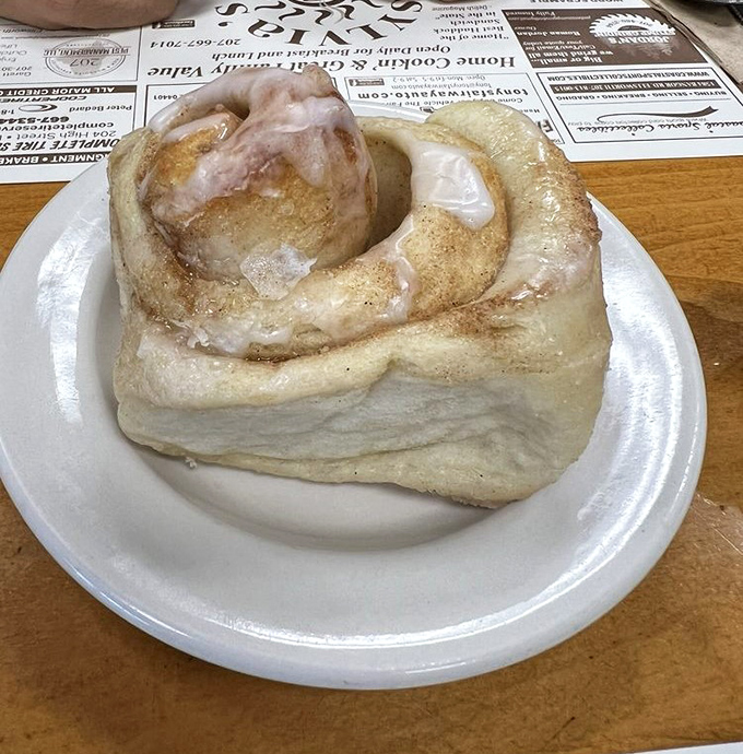 This cinnamon roll isn't just a pastry; it's an event. Pillowy soft with that perfect spiral of cinnamon and sugar, crowned with a glaze that glistens like morning dew.