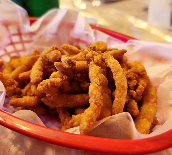 Golden-fried clam strips nestled in their basket—crunchy on the outside, tender within, and utterly impossible to share.