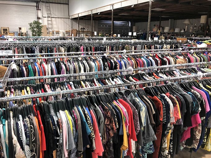 The clothing section stretches toward infinity, a textile galaxy where vintage treasures orbit alongside barely-worn basics.