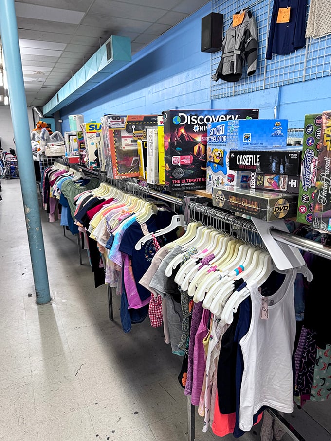 Children's clothes and boxed toys line the blue walls, proving kids can look adorable without parents taking out a second mortgage.