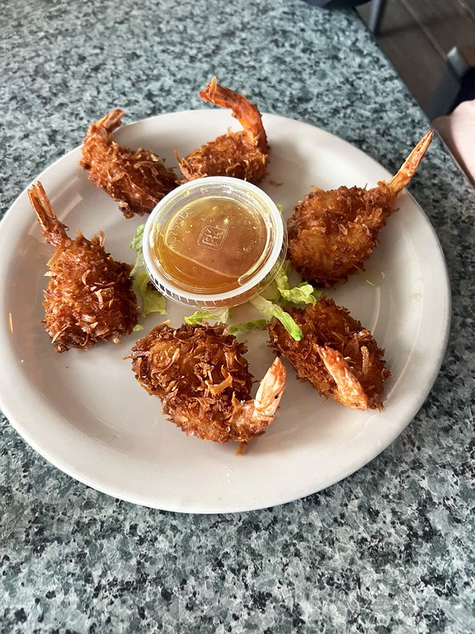 Coconut shrimp arranged like a sunburst around dipping sauce&mdash;tropical Florida on a plate, no passport required.