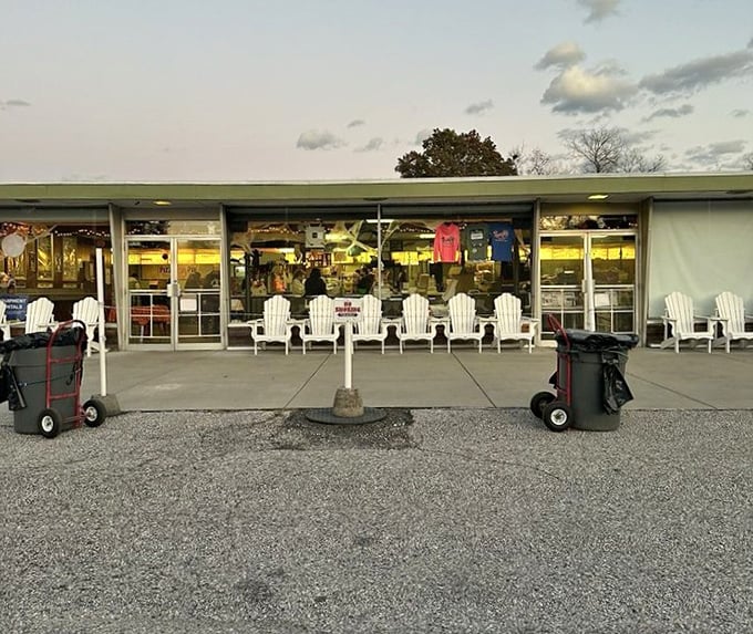 White Adirondack chairs invite early arrivals to stretch their legs before settling in for a double feature.