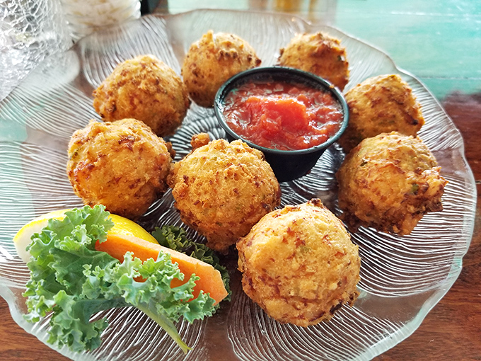 Golden orbs of conch fritter goodness &ndash; crispy outside, tender inside. The marinara dipping sauce seals the deal.