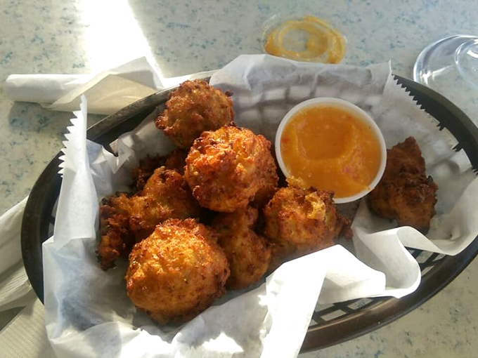Conch fritters golden as doubloons, crispy outside and tender within—the Caribbean's gift to bar food perfection.