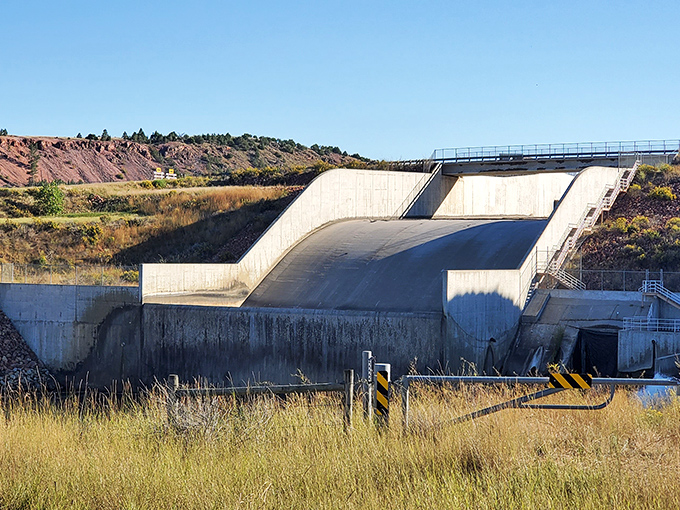 The dam spillway: an engineering marvel that somehow manages to look both imposing and elegant, like concrete origami.
