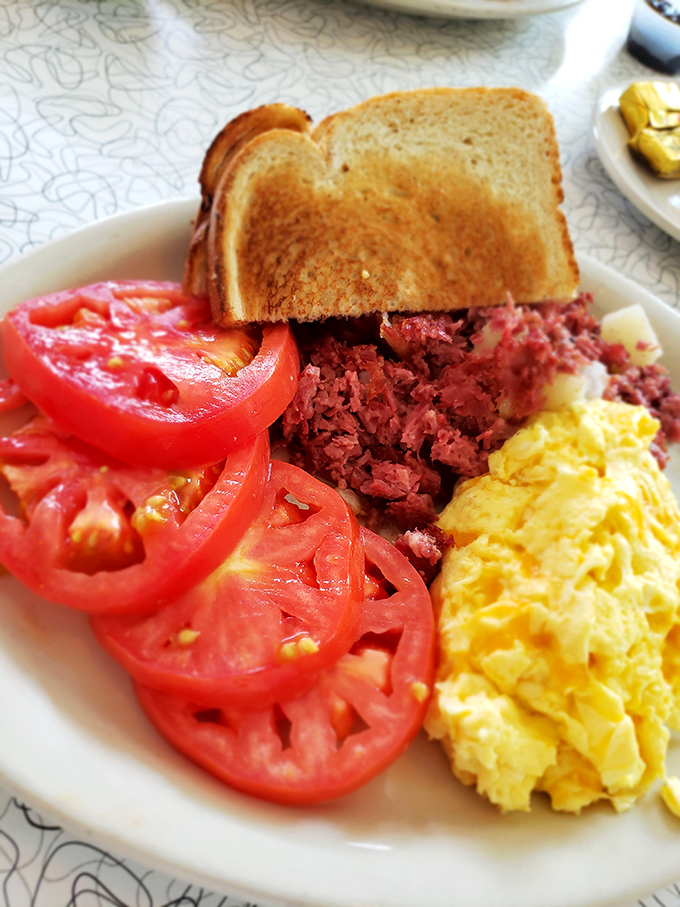 Corned beef hash with eggs and tomatoes&mdash;the breakfast of champions who understand that mornings deserve more than just a boring granola bar.