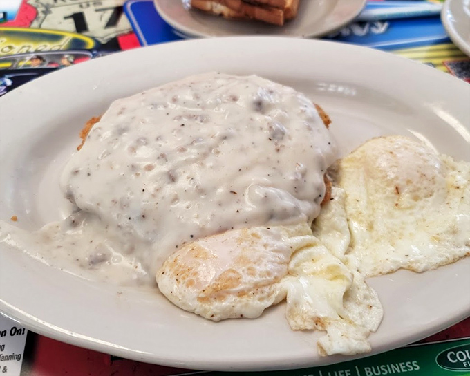 Country fried steak smothered in pepper gravy with eggs&mdash;the kind of breakfast that makes you want to cancel your plans and take a nap afterward.
