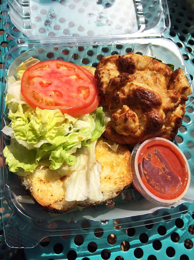 Maryland's state religion: the perfect crab cake. Served on a toasted roll with just enough garnish to complement, not compete with, the star.