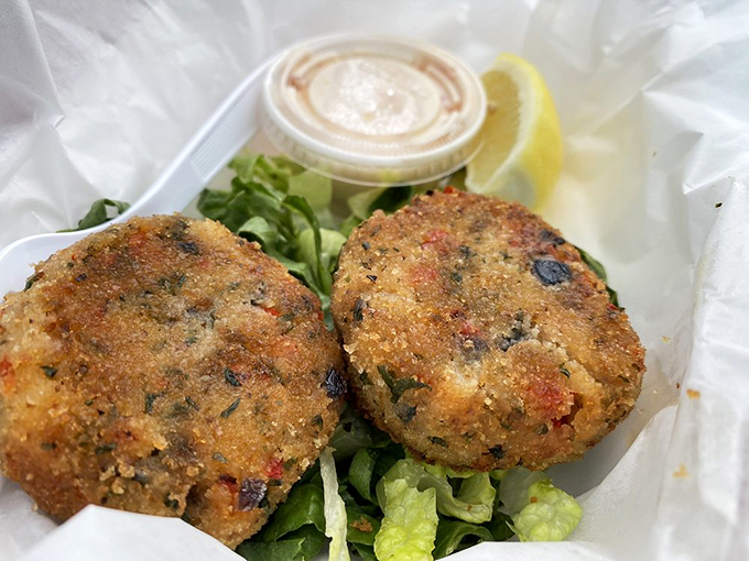 Golden-brown crab cakes that could make a New Englander weep with joy, served with the perfect touch of sauce and lemon.