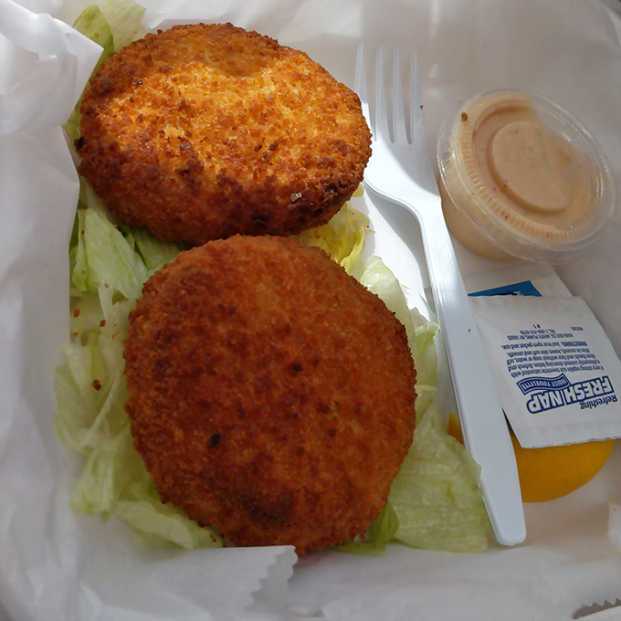 Golden-fried crab cakes that don't hide behind fillers &ndash; just sweet lump crab meat with a crispy exterior that shatters with each bite.