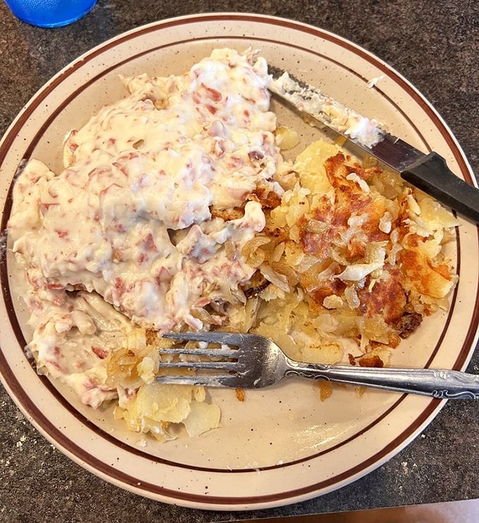 Creamed chipped beef cascades over this plate like comfort food royalty, accompanied by perfectly crisped hash browns for good measure.