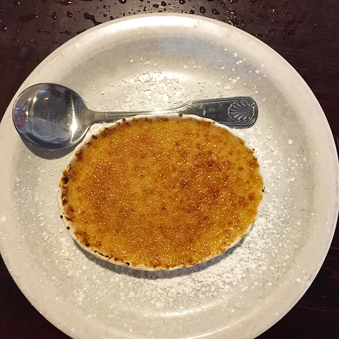 The cr&egrave;me br&ucirc;l&eacute;e's perfectly torched top waits to be cracked like nature's most delicious geode. Spoon-wielding archeologists welcome.