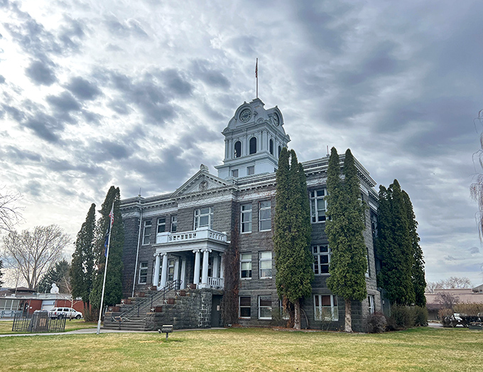 Crook County's historic courthouse stands as a dignified reminder of Prineville's past, surrounded by evergreens that have witnessed generations of local history.