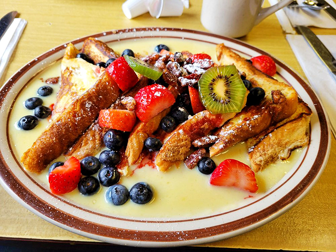French toast that belongs in the Louvre&mdash;golden slices adorned with berries, kiwi, and powdered sugar that would make even Marie Antoinette say "let them eat breakfast!"