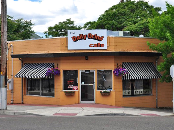 The Daily Grind Cafe's cheerful facade and striped awnings promise that perfect morning cup &ndash; the fuel for small-town adventures.