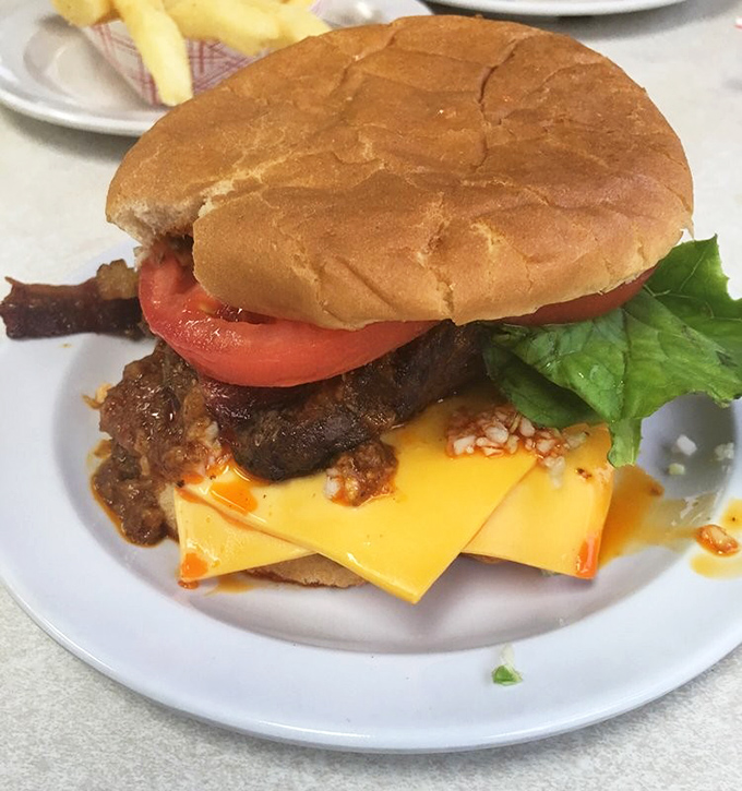 The burger holds its own against its hot dog siblings—a hand-patted beauty topped with chili, cheese, and fresh veggies.