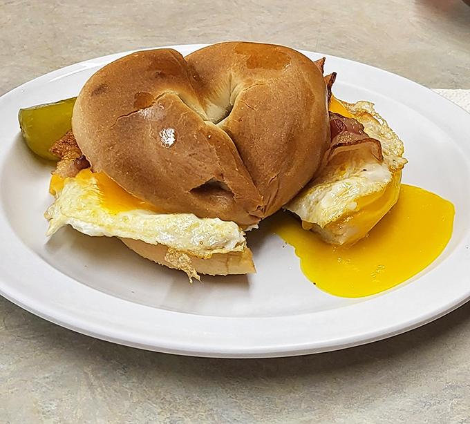 The breakfast sandwich that launched a thousand satisfied sighs. That yolk is about to create the kind of mess worth cleaning up.