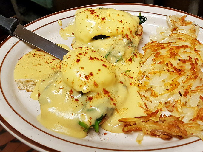 Eggs Benedict: where hollandaise sauce flows like liquid gold and hash browns achieve that mythical crisp-yet-tender balance. Morning magnificence on a plate.