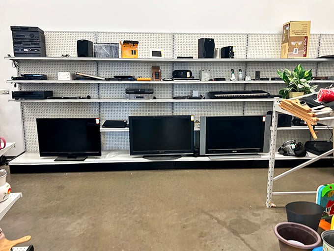 Yesterday's electronics find new purpose on these shelves, where vintage stereo equipment sits alongside modern flat-screen TVs.