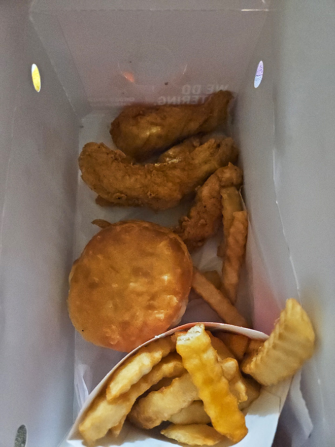 Fast-food nirvana in a box: golden fish, crispy chips, and that legendary biscuit that never survives the ride home.