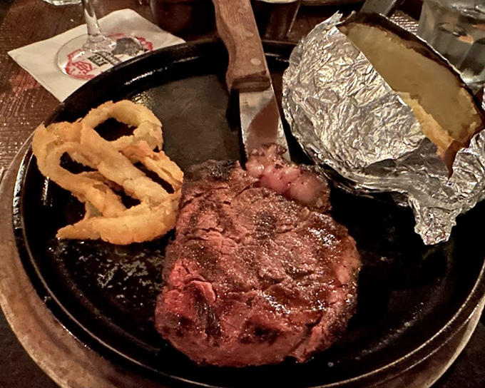 That filet with onion rings and baked potato is the holy trinity of steakhouse dining done absolutely right.