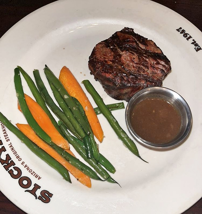 This filet mignon with seasonal vegetables isn't just dinner &ndash; it's edible artwork. The sauce cup stands by like a faithful sidekick, ready when needed.