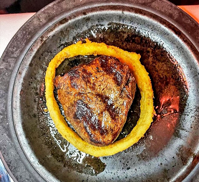 A filet mignon surrounded by a golden onion ring&mdash;like Saturn with its rings, but infinitely more delicious and definitely worth the trip. 