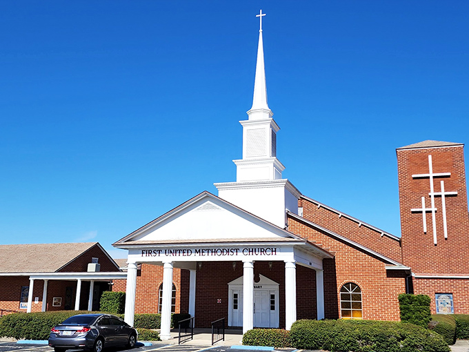 First United Methodist's pristine white steeple reaches skyward, a spiritual landmark that's been guiding souls longer than GPS has guided tourists.
