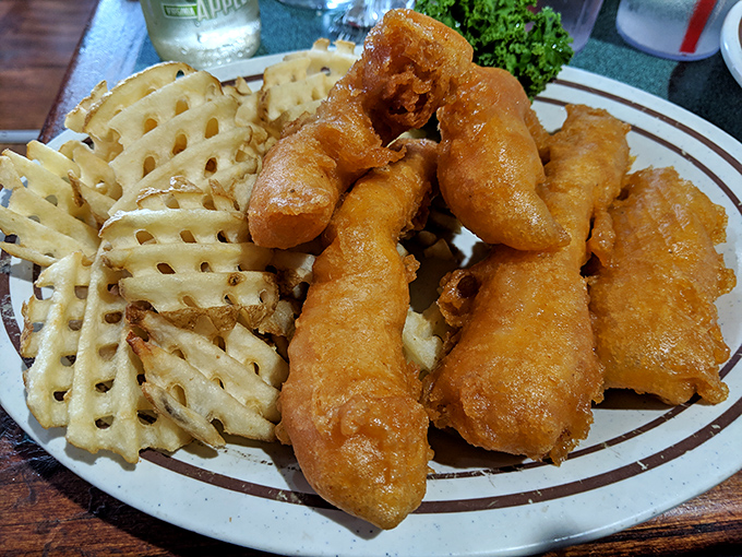 Fish and chips that would make a British pub jealous, with waffle fries that deserve their own fan club and membership cards.