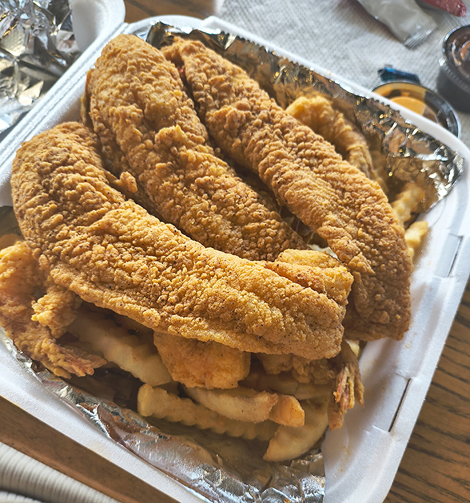 Golden-battered fish fillets resting atop crispy fries&mdash;the kind of fish and chips that makes you wonder why you'd eat anything else.