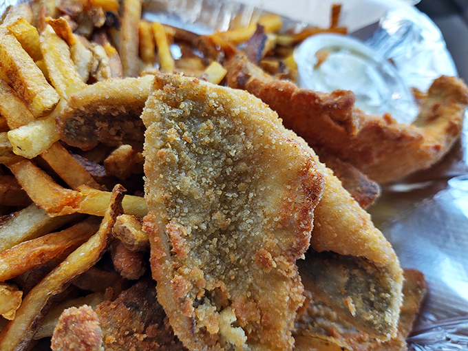 Golden-battered fish nestled among crispy fries&mdash;the kind of comfort food that makes you temporarily forget that vegetables exist.