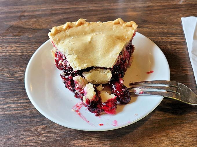 This berry pie isn't just dessert&mdash;it's edible poetry. The flaky crust barely contains its ruby filling, while that fork stands ready for the inevitable surrender.