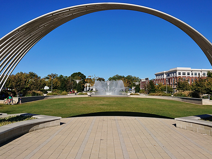 Fountain Park's sweeping arch frames a perfect urban oasis. This modern gathering space proves small towns can deliver big-city amenities without the big-city price tag.