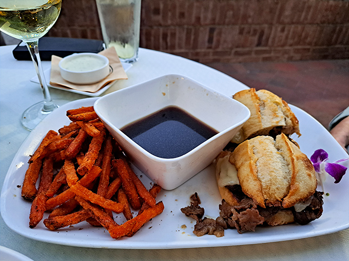 That French dip sandwich with sweet potato fries proves even the non-steak options deserve serious respect and attention here.