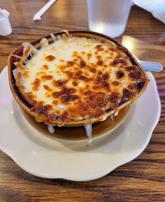 French onion soup with a cheese cap so perfect it deserves its own superhero movie. The battle between your spoon and that cheese is epic.