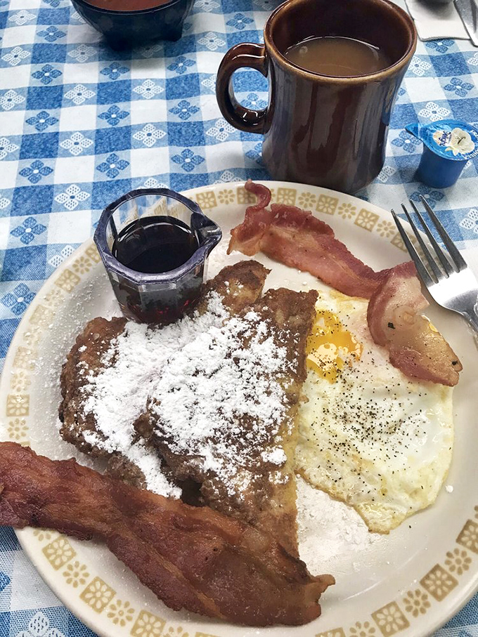 French toast dusted with powdered sugar, flanked by bacon sentries – breakfast's answer to having your cake and eating protein too.