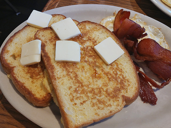 French toast that's achieved the impossible trifecta: perfectly golden exterior, custardy interior, and enough butter squares to make Wisconsin proud.