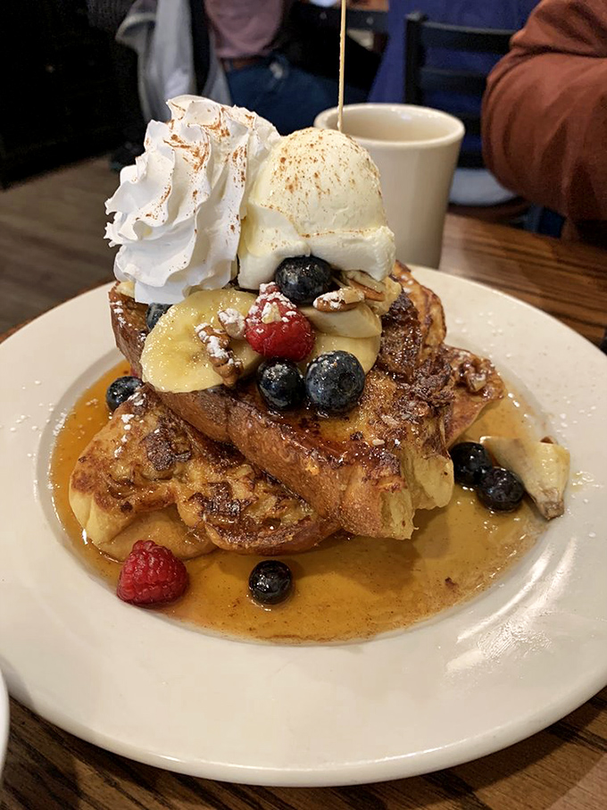French toast architecture at its finest&mdash;layers of challah supporting fresh berries, whipped cream, and ice cream in a tower of breakfast decadence.