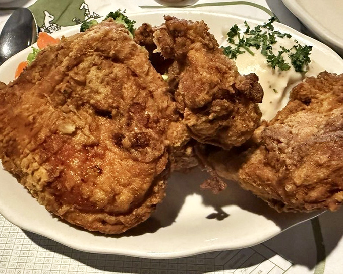 Fried chicken so perfectly golden it belongs in Fort Knox. The kind of crunch that makes strangers at nearby tables look over with envy.