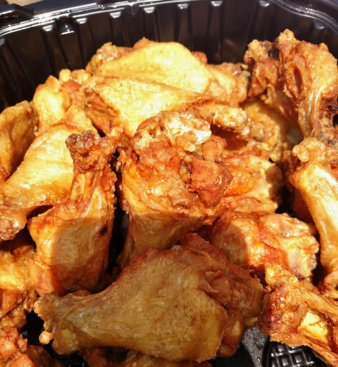 Naked wings fresh from the fryer, showcasing that perfect crisp-tender balance before their sauce baptism. The foundation of greatness.