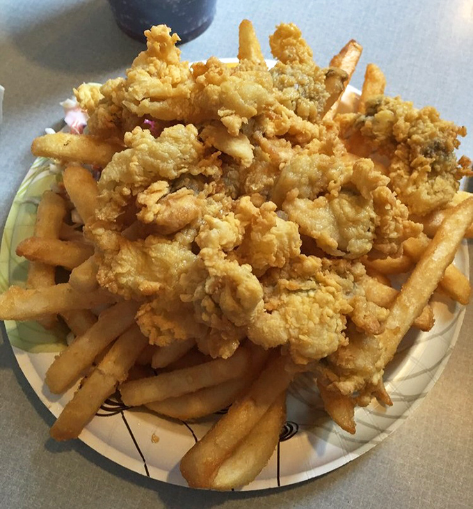 Fried clams and fries stacked higher than Maine's lighthouse beacons. Golden, crispy, and worth every napkin you'll need afterward.