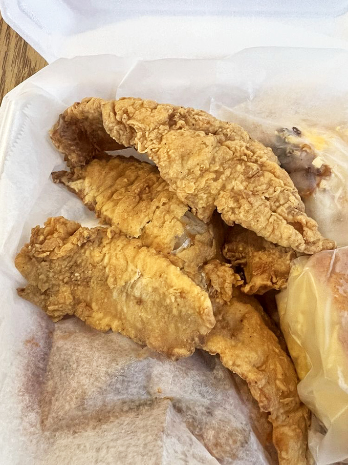 Golden-fried whiting that shatters at first bite, revealing flaky white fish that needs nothing more than a squeeze of lemon to achieve perfection.