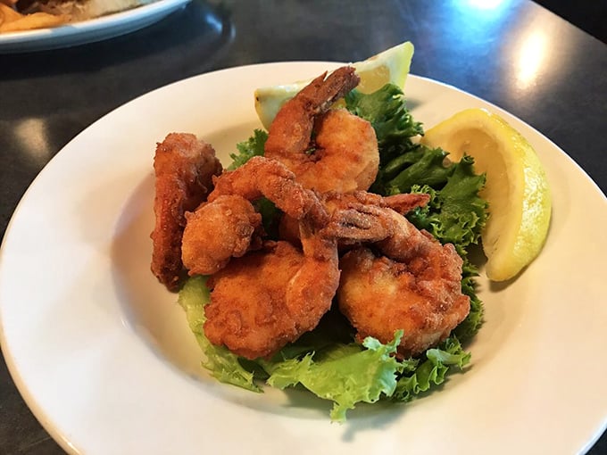 These aren't just fried shrimp &ndash; they're golden-armored ocean jewels. Perfectly crisp outside, tender within, they're begging for a squeeze of that lemon.
