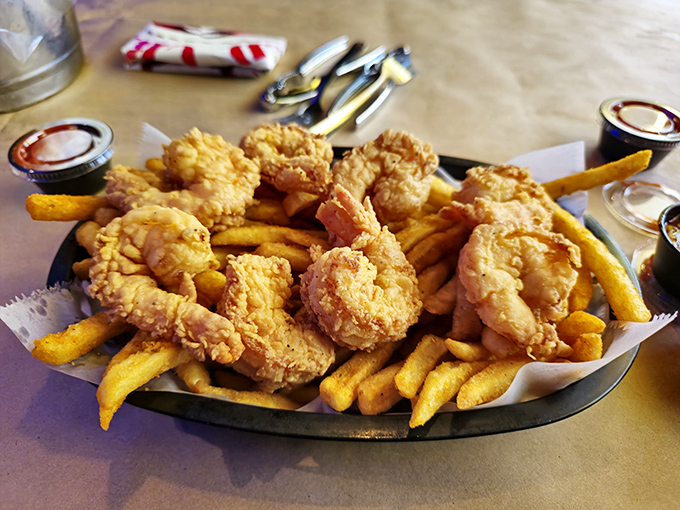 Golden-fried shrimp nestled among crispy fries &ndash; proof that sometimes the simplest pleasures are the most satisfying. The perfect gateway dish for seafood skeptics.