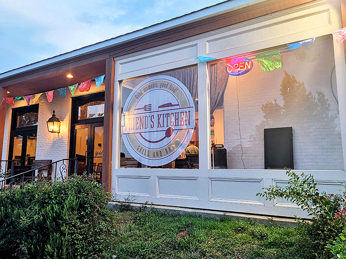Friend's Kitchen glows with welcoming warmth as evening approaches. Those colorful pennants aren't just decoration&mdash;they're a promise of celebration on your palate.