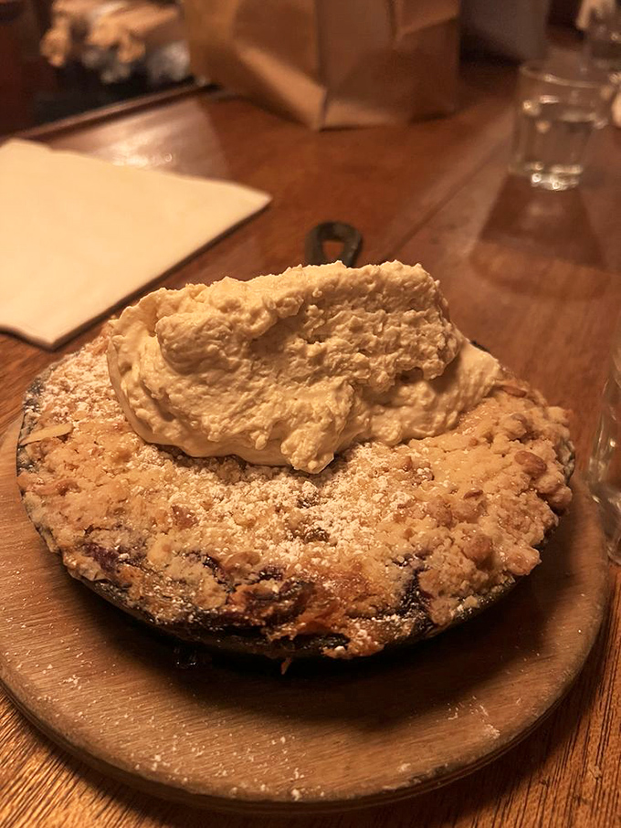 This berry cobbler isn't just dessert; it's the grand finale to a memorable meal, crowned with a cloud of homemade whipped cream.